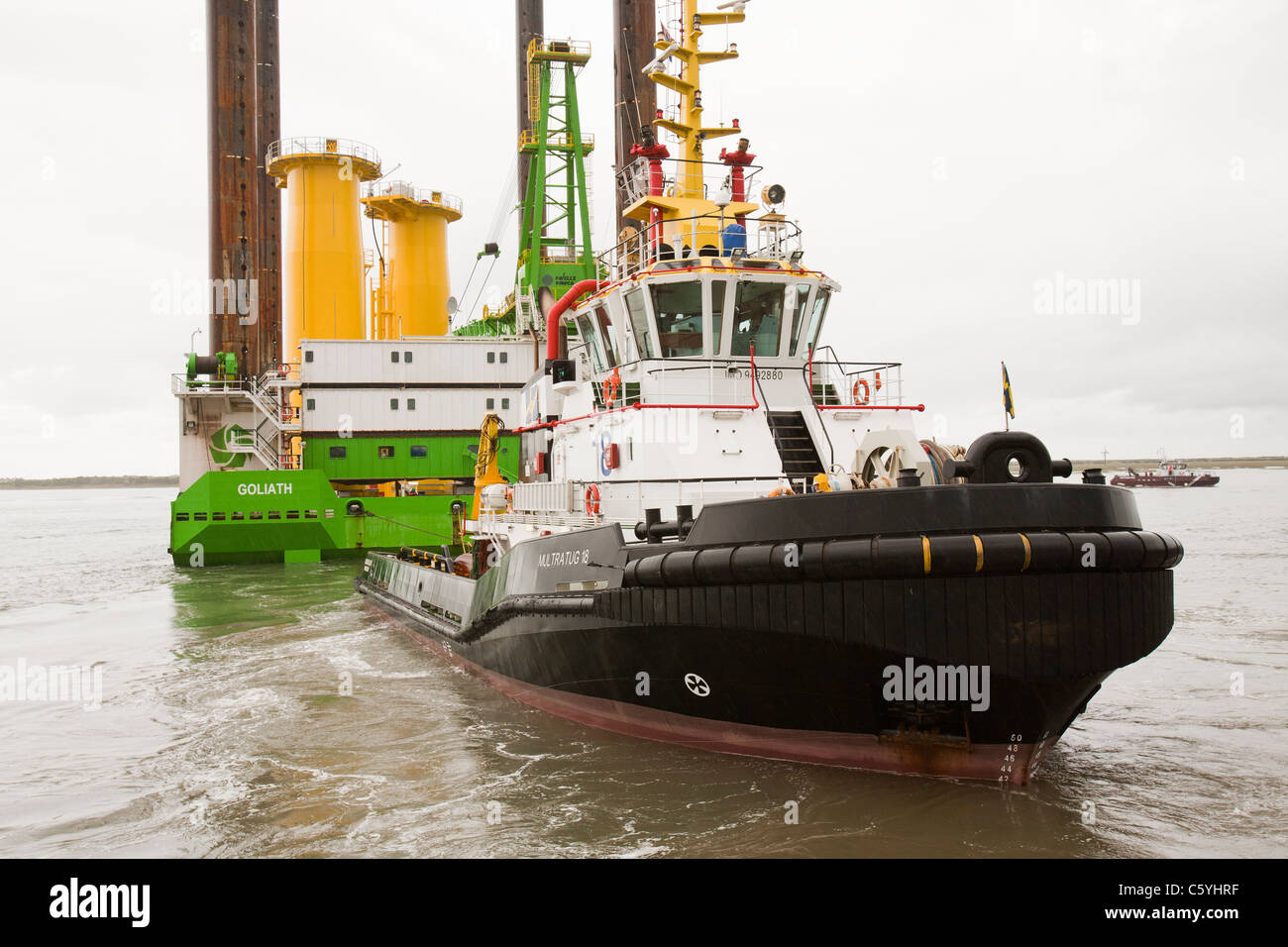 The jack up barge, Goliath being towed out by tug to the Walney ...