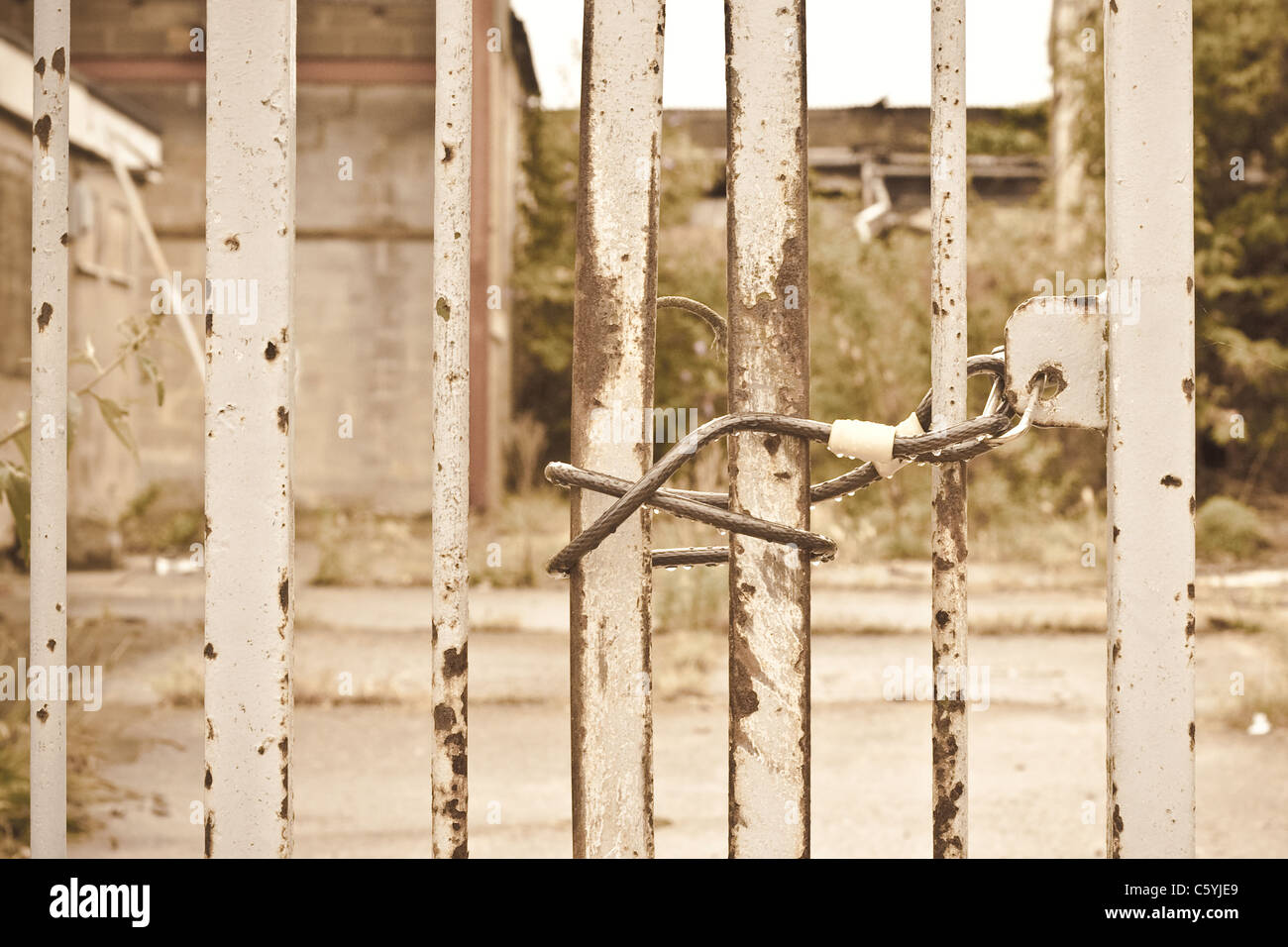 Close up of a locked gate to a scrapyard in vintage colours Stock Photo ...