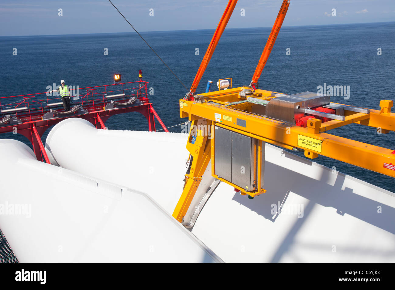A turbine blade being lifted off a jack up barge to fit onto a wind ...