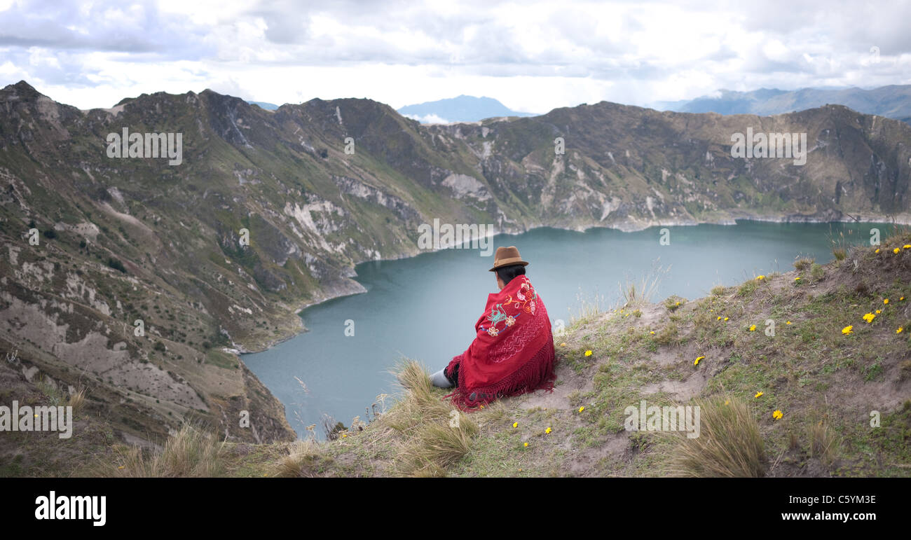 Indigenous woman sitting on volcano crater edge Stock Photo - Alamy