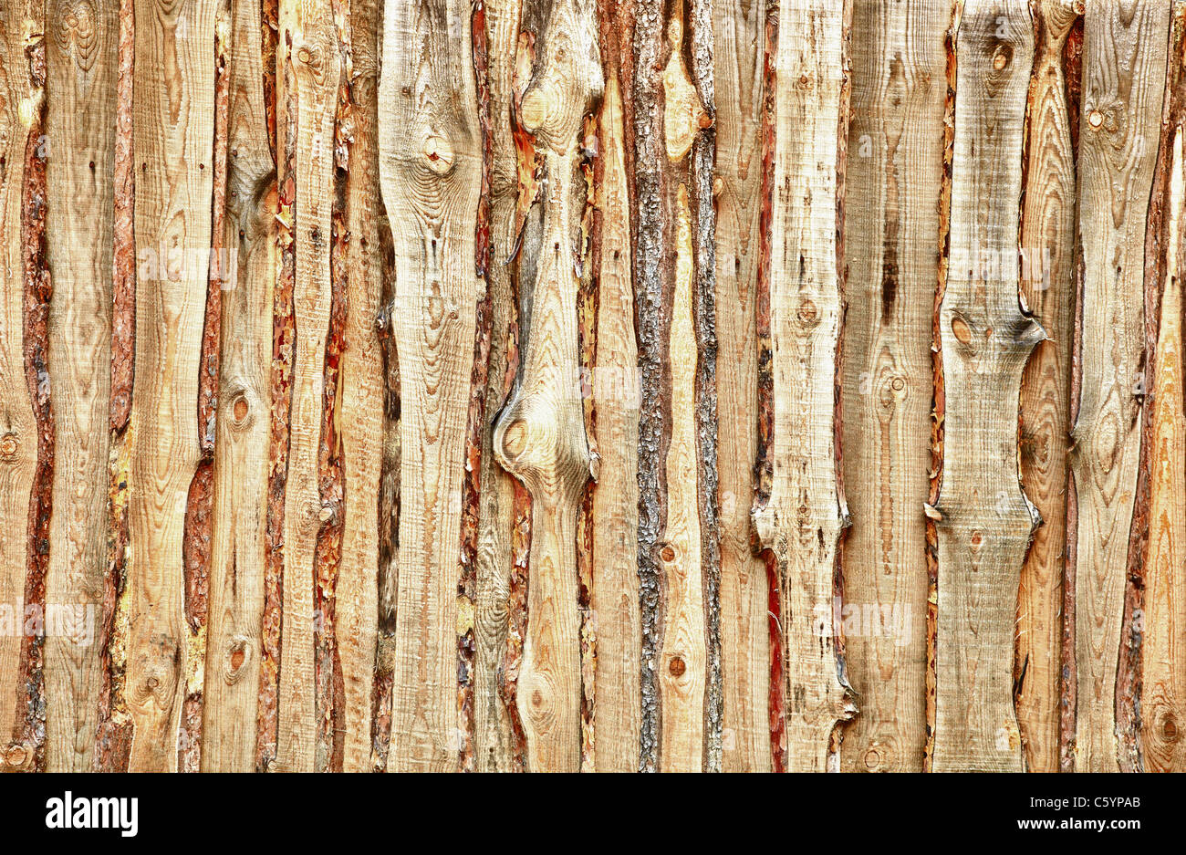 A fence made of rough wooden planks and slabs Stock Photo - Alamy