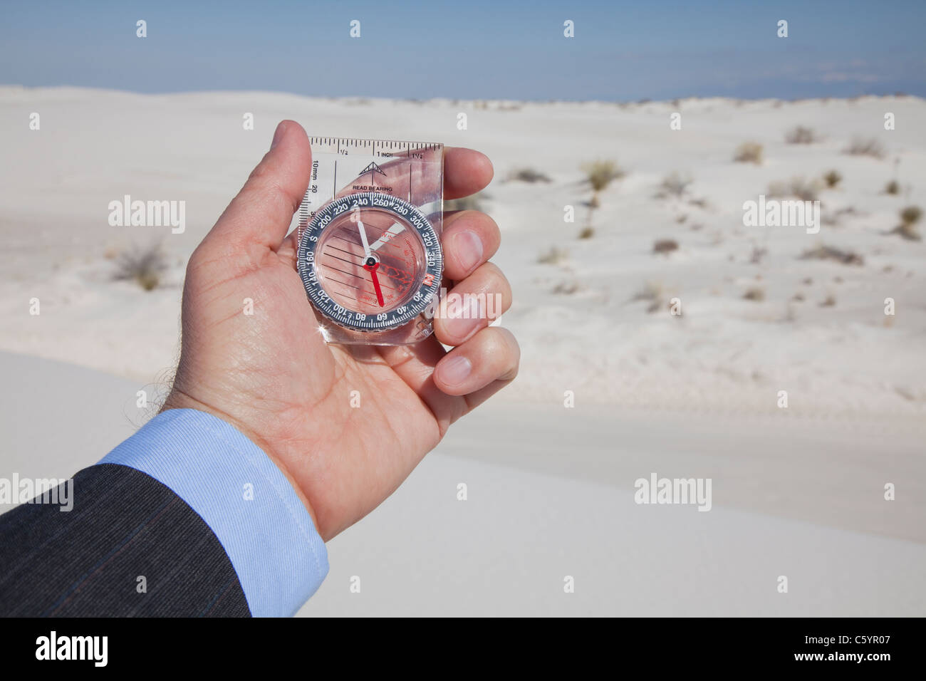 USA, New Mexico, Whitesands, Hand holding compass on desert Stock Photo ...