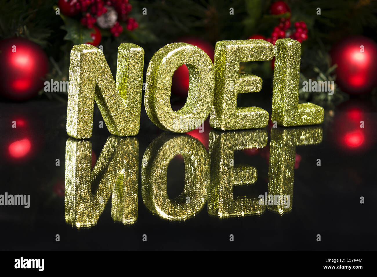 In capital letter written noel, glitter effect over black Stock Photo ...
