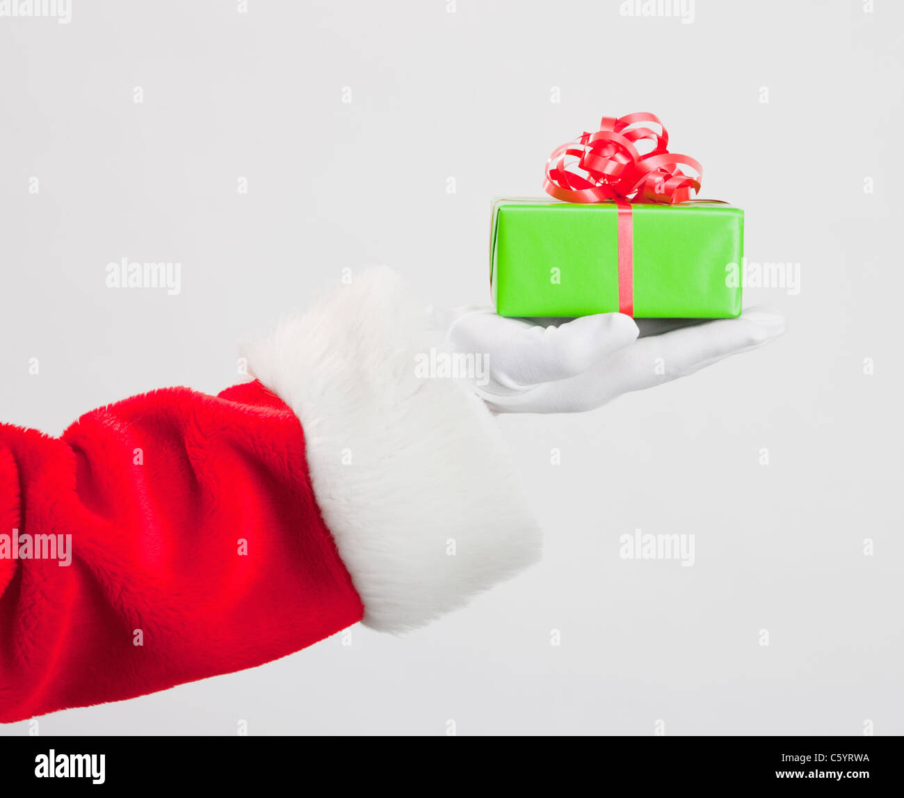 Santa clause holding Christmas gift Stock Photo - Alamy