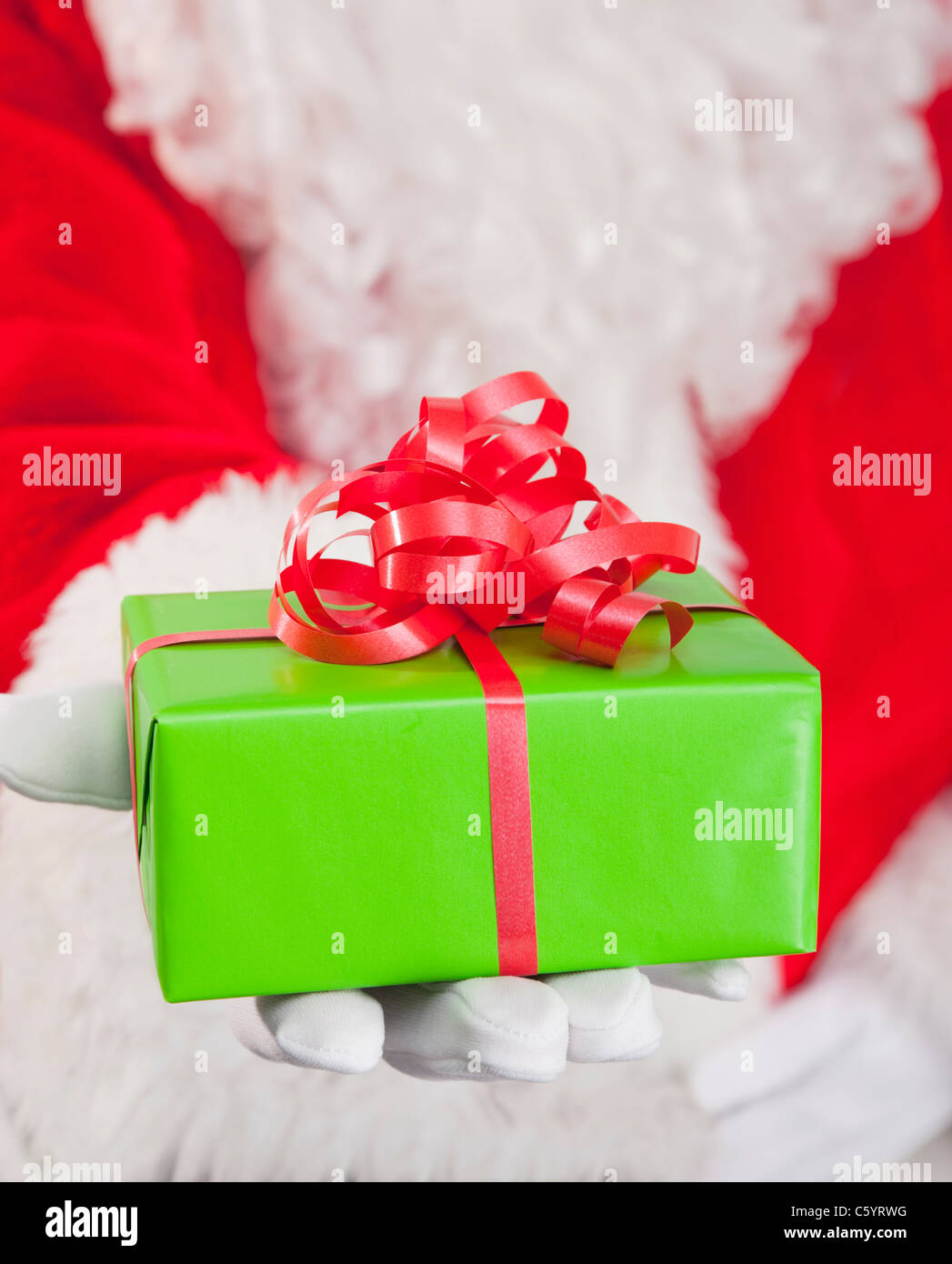 Santa clause holding Christmas gift Stock Photo - Alamy