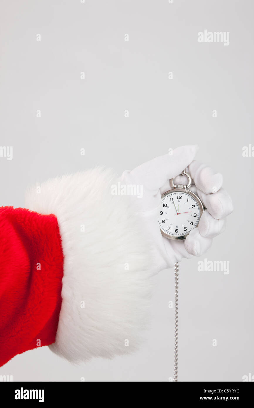 Santa clause holding pocket watch Stock Photo - Alamy