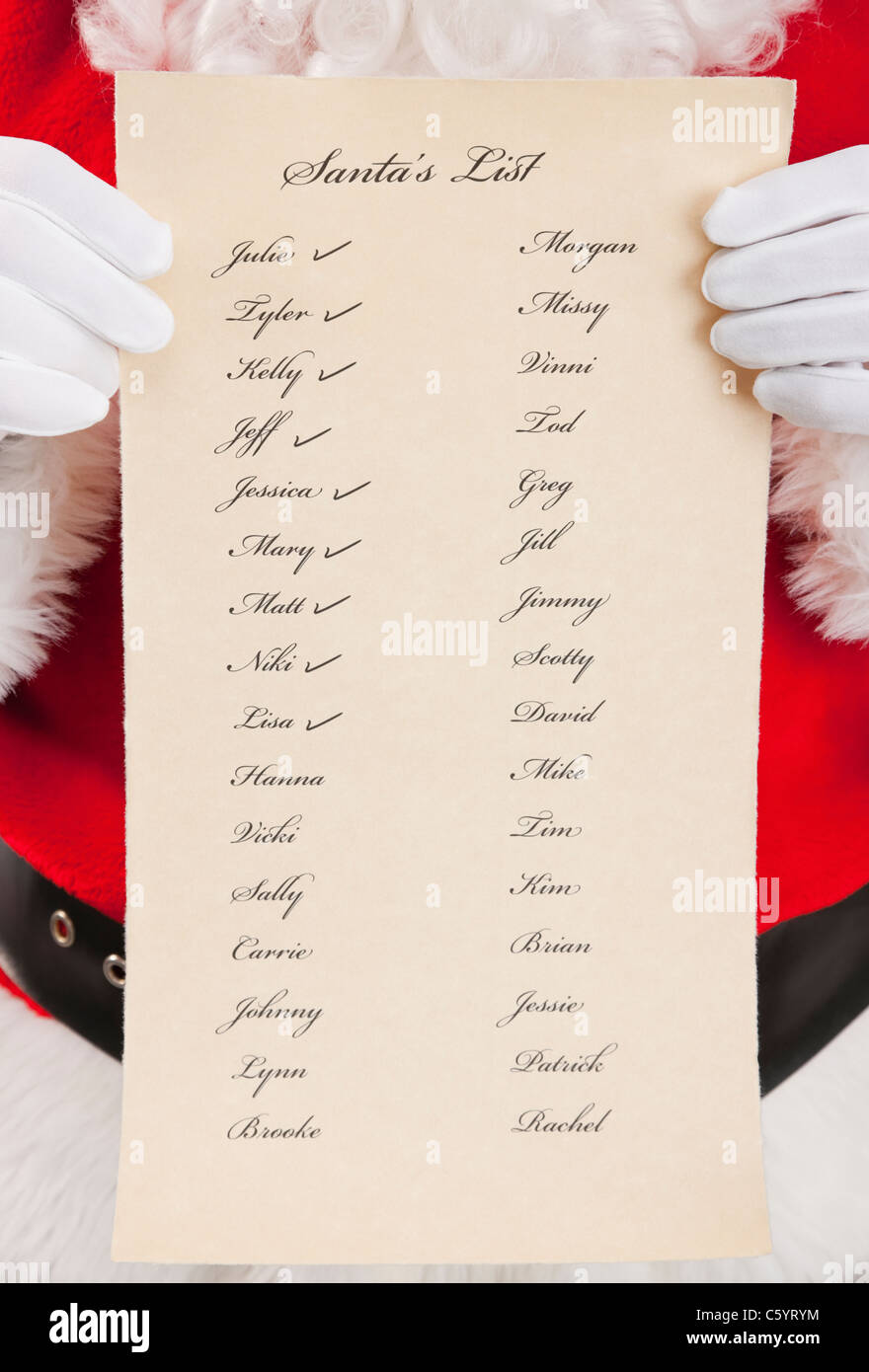 Santa clause holding Christmas list Stock Photo - Alamy