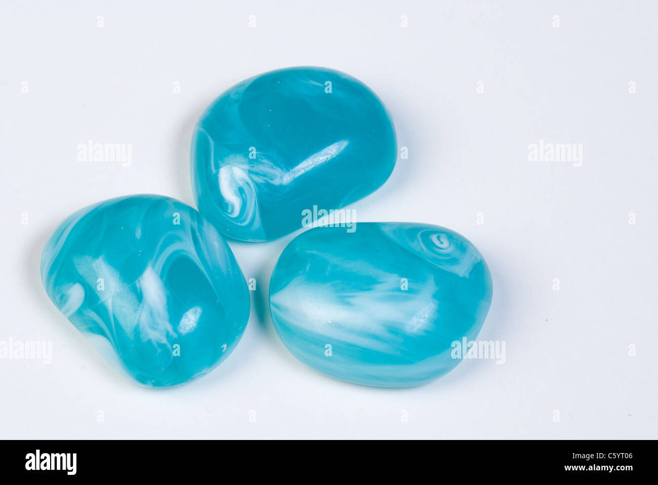 Blue marbled rounded stones isolated on white Stock Photo - Alamy