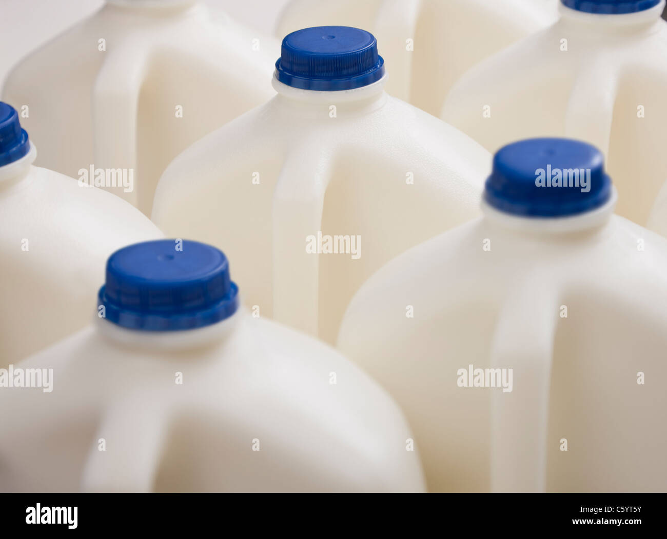 Milk bottles with blue caps Stock Photo - Alamy