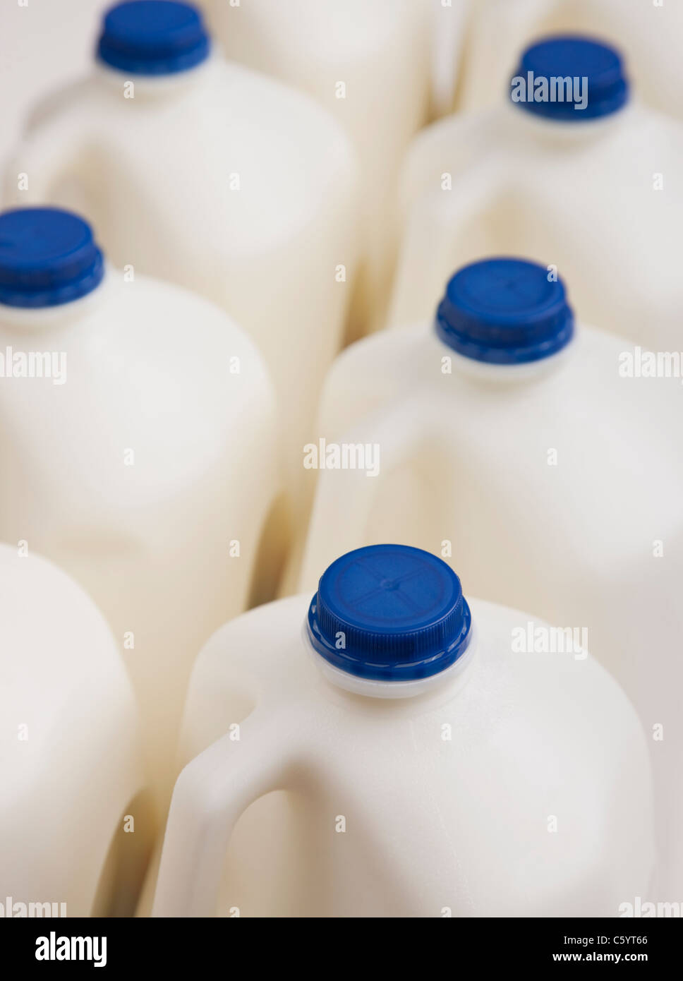Milk bottles with blue caps Stock Photo - Alamy