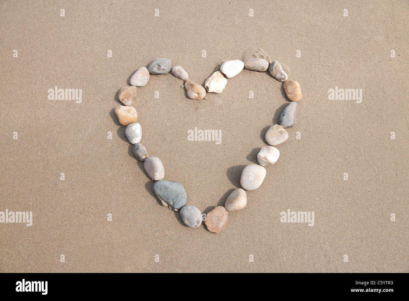 Heart made of Pebbles on a beach Stock Photo - Alamy