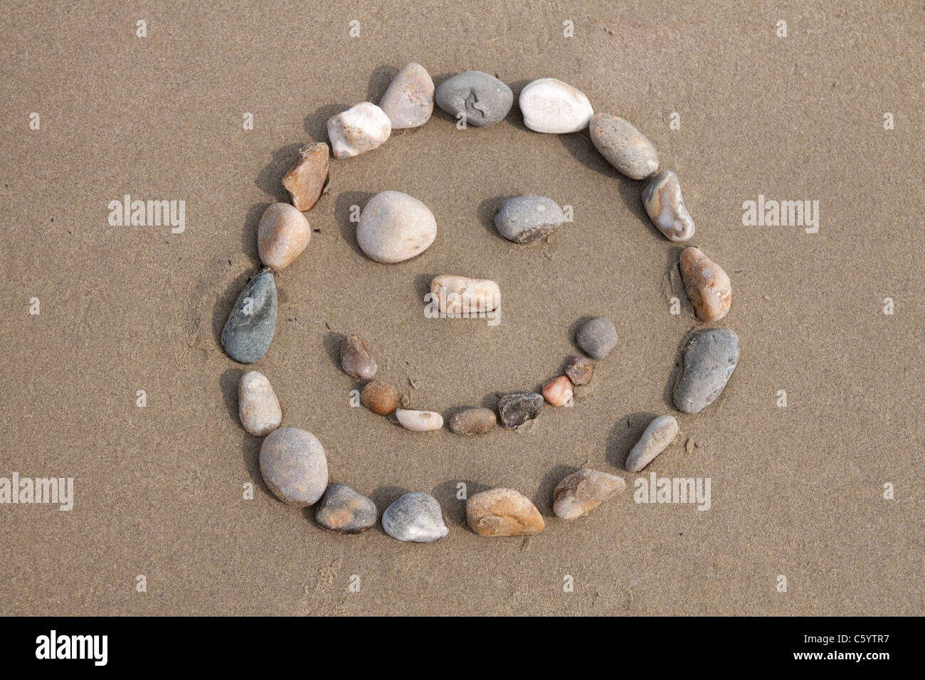 Smiling face made from pebbles on a Beach Stock Photo - Alamy