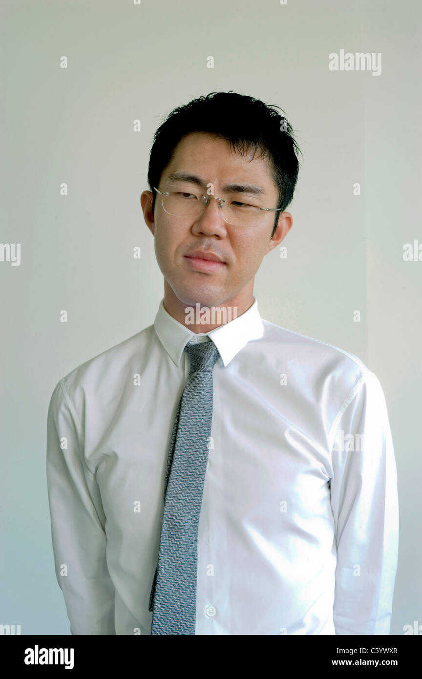 Portrait young Asian Businessman Looking down, in Medium Shot, man face ...
