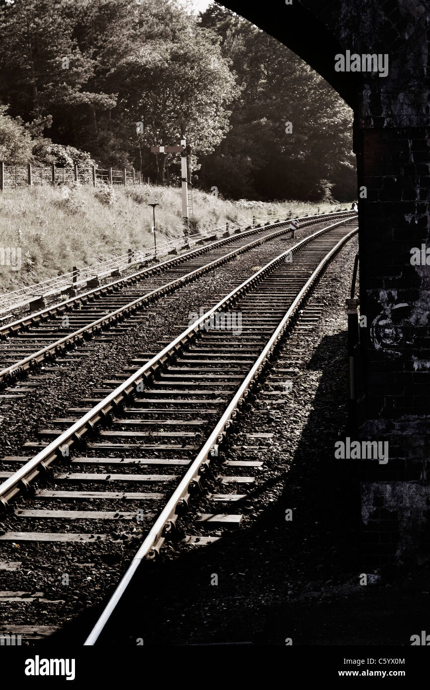 Railway line passing under a bridge and disappearing into the distance ...