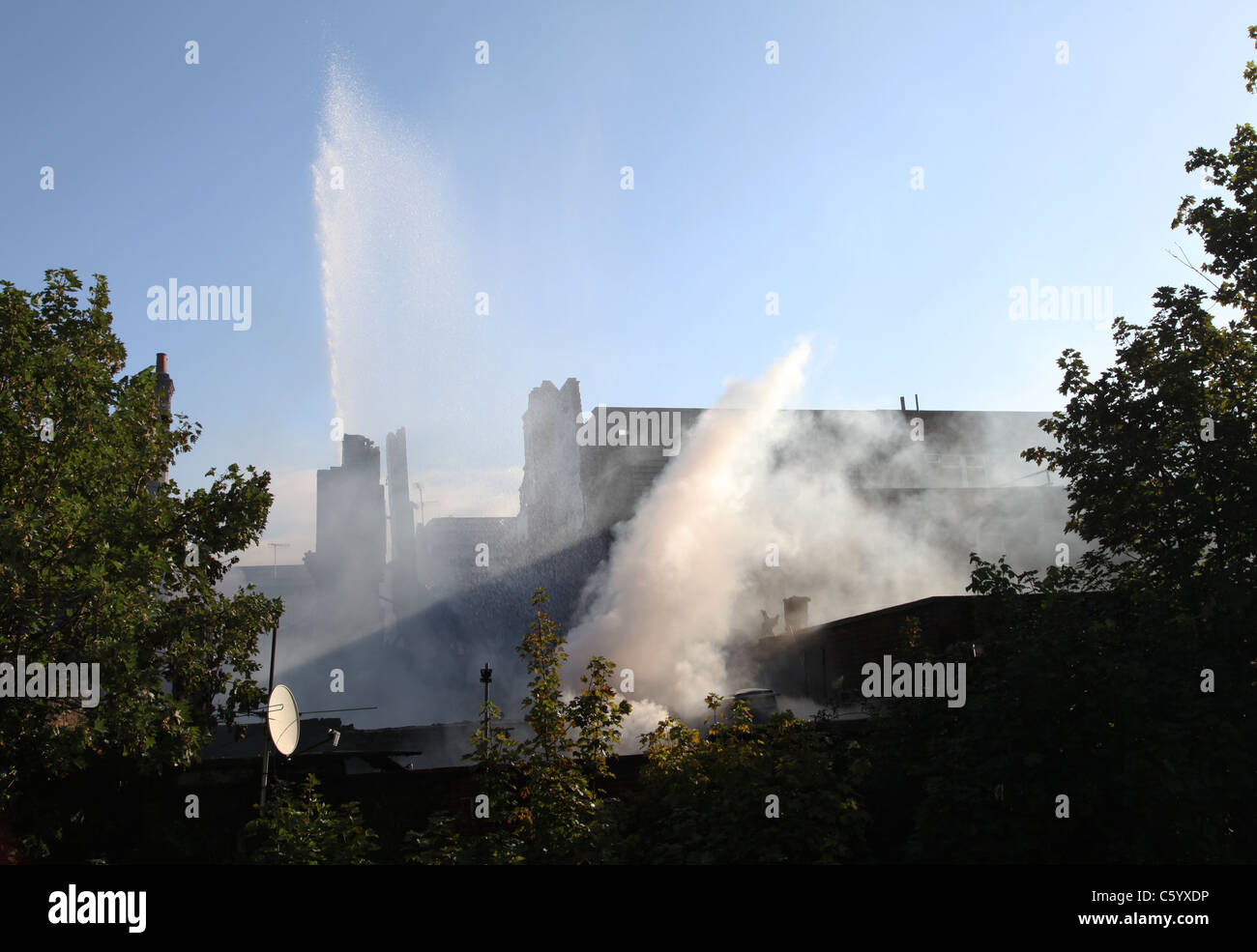 Garden fire being extinguished Stock Photo - Alamy