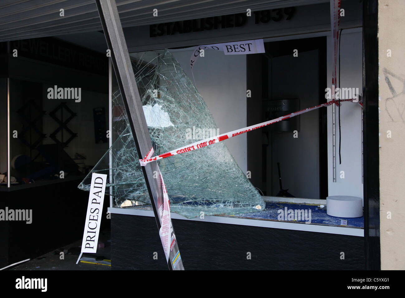 Vandalized and robbed shop window smashed in rioting Stock Photo - Alamy
