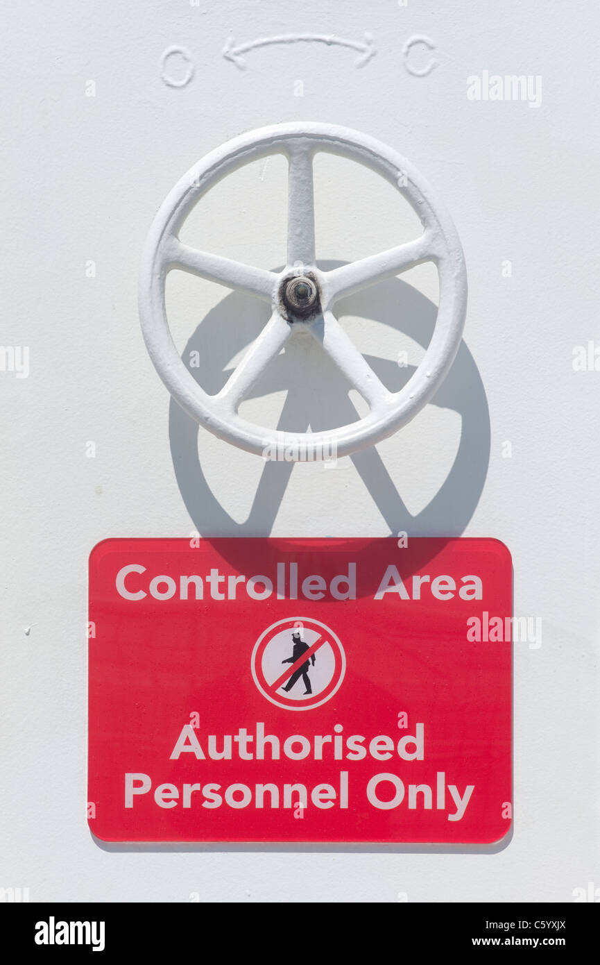 Controlled Area Sign on a ship with a metal turning wheel on white ...