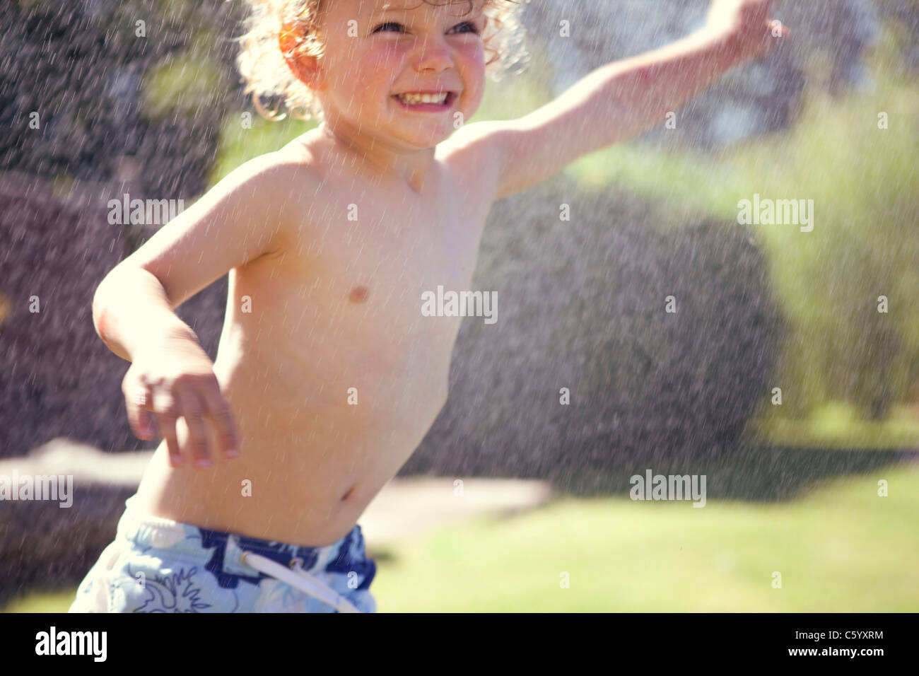 Child plays with water spray hi-res stock photography and images - Alamy