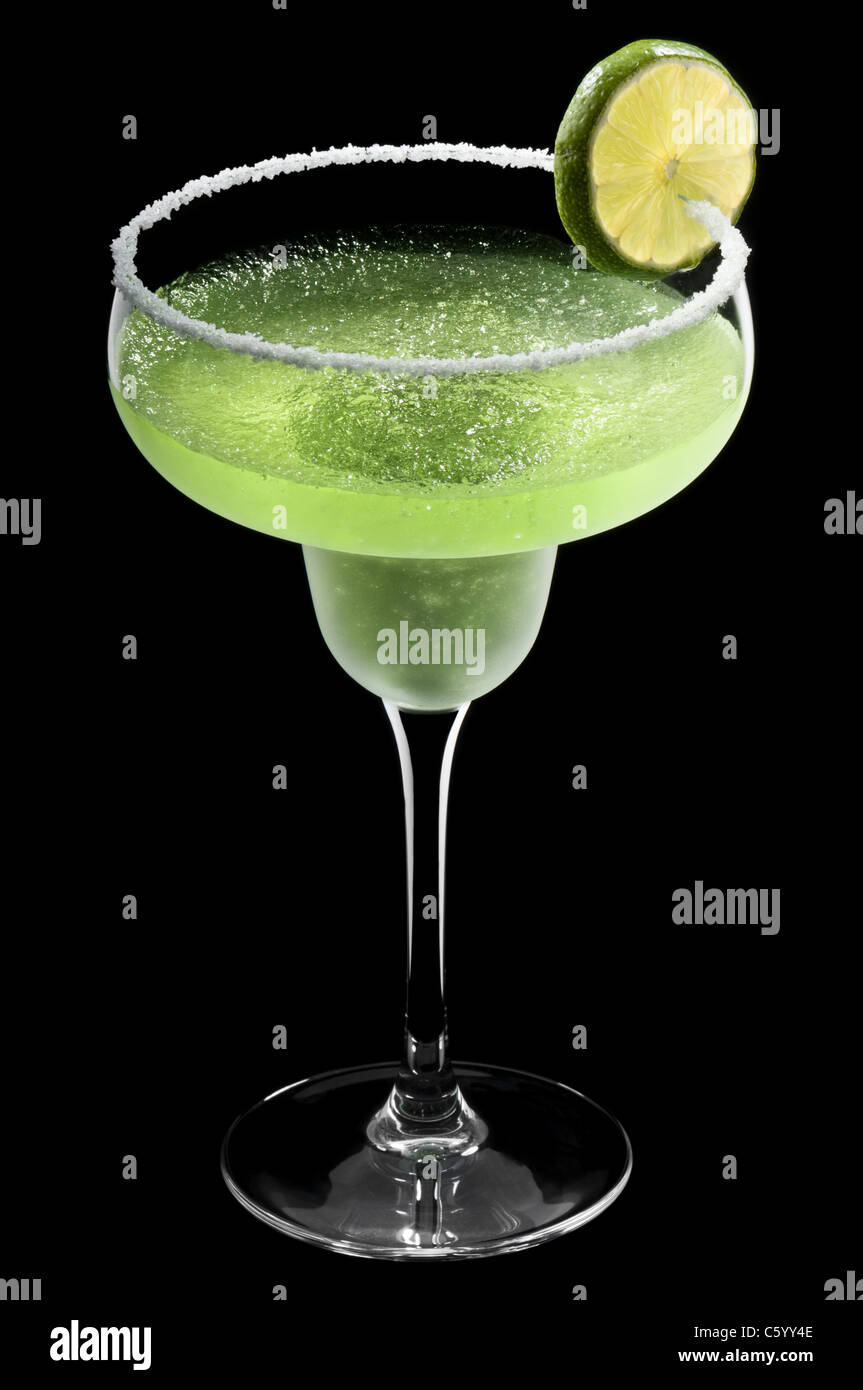 Green Margarita in front of a black background with fresh garnish Stock ...