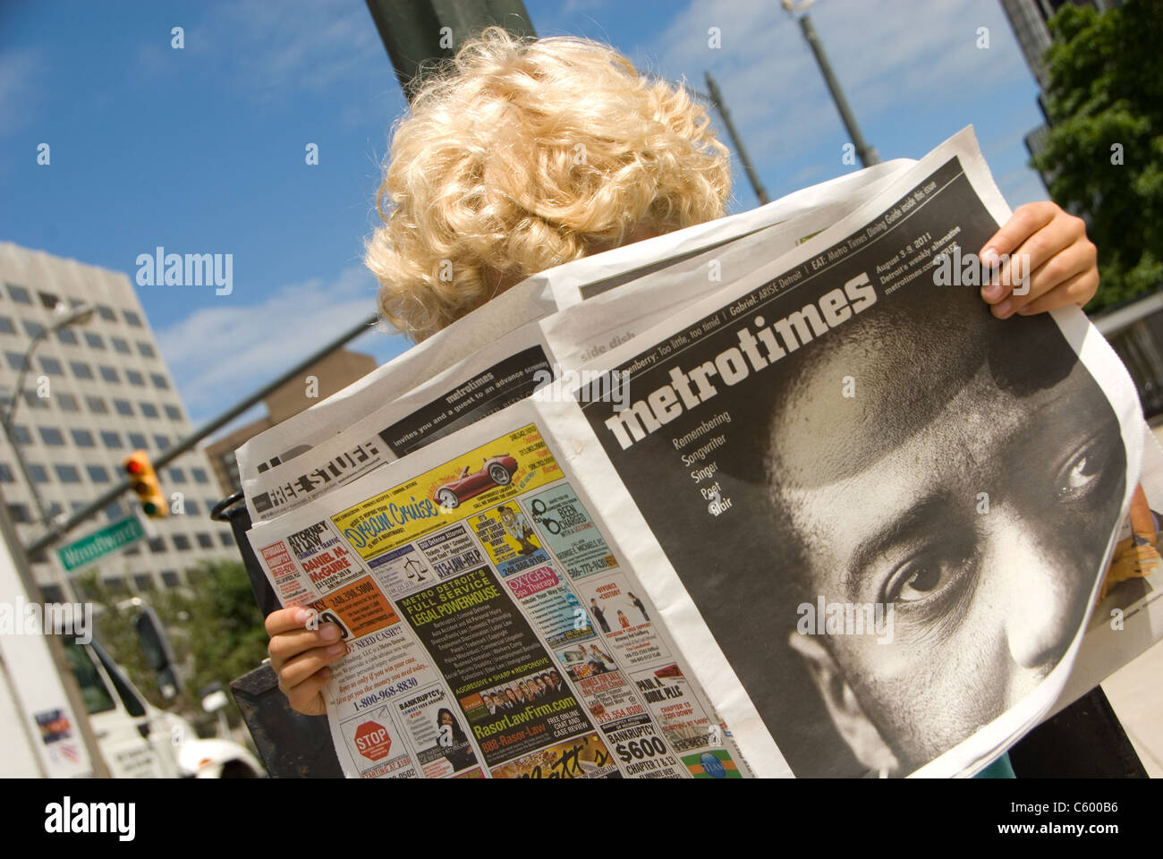 Young boy reads Metro Times newspaper in downtown Detroit, Michigan on ...