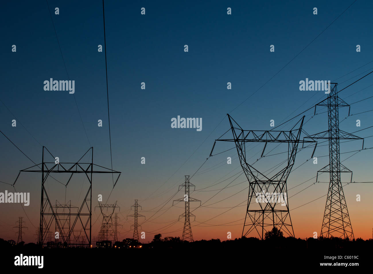 A long line of electrical transmission towers (electricity pylons ...