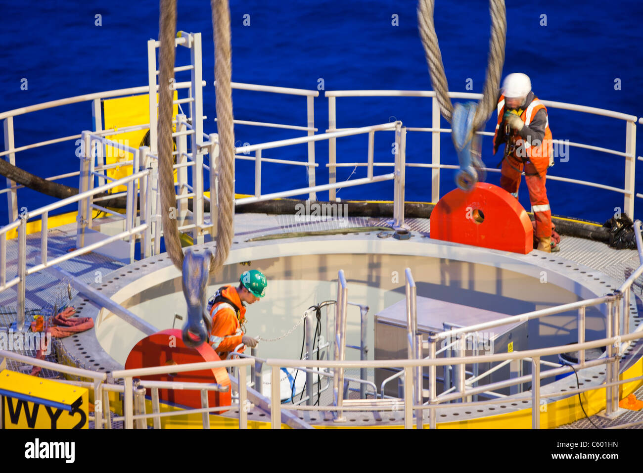 workers fixing a transition piece into place on the Walney offshore ...