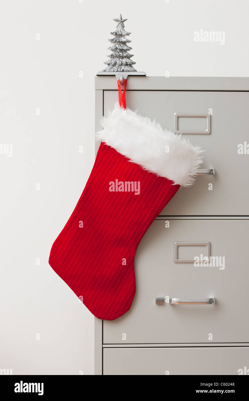 Studio shot of filing cabinet with small Christmas tree and Christmas ...