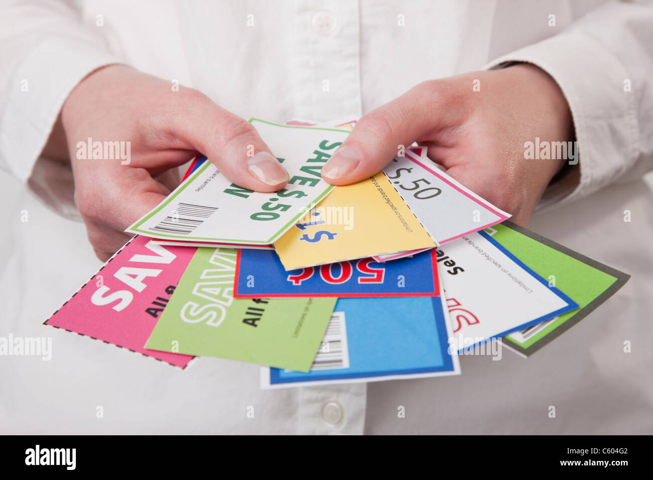 Hands holding coupons Stock Photo - Alamy