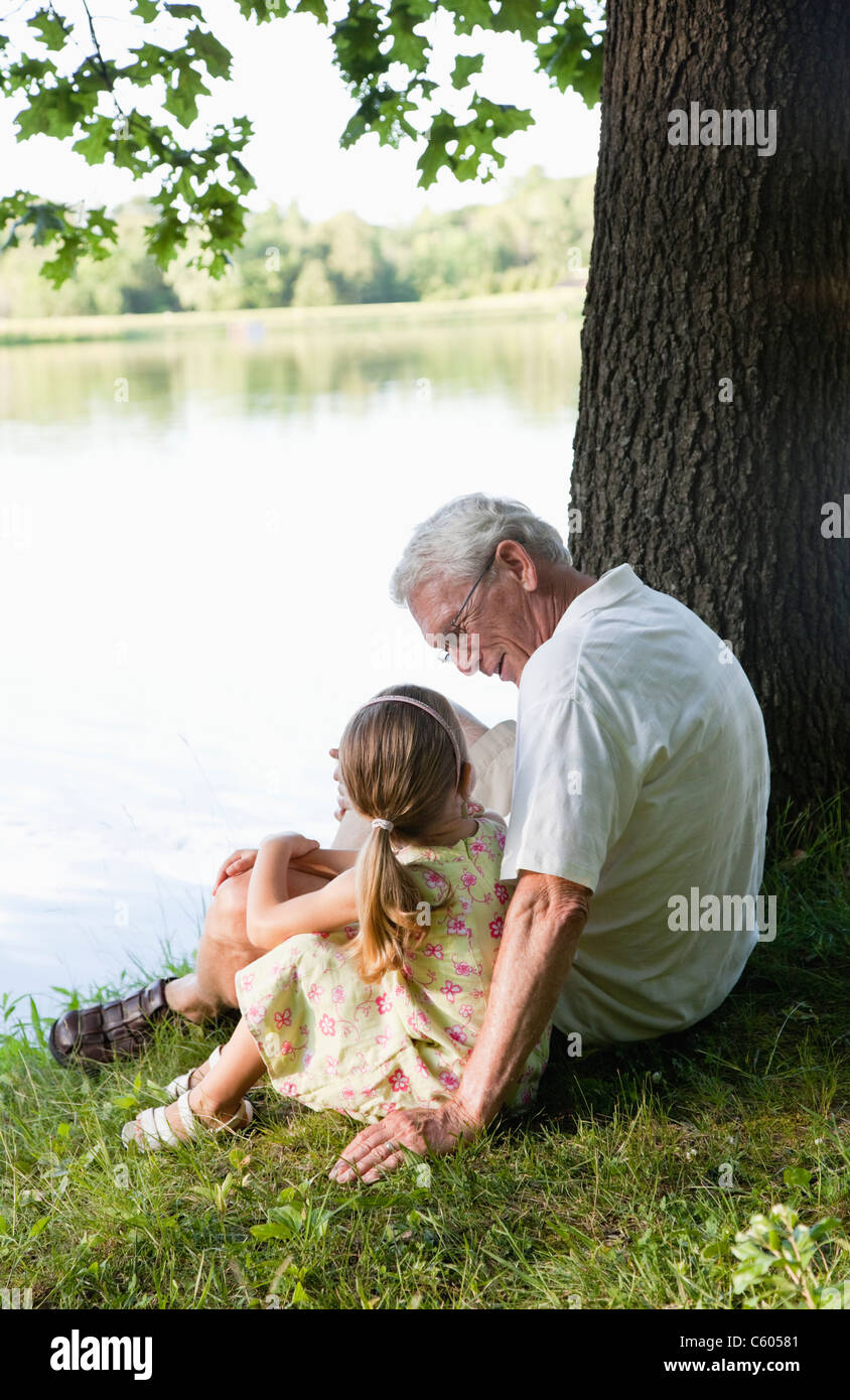 USA, Illinois, Metamora, grandfather and granddaughter (4-5) sitting at ...