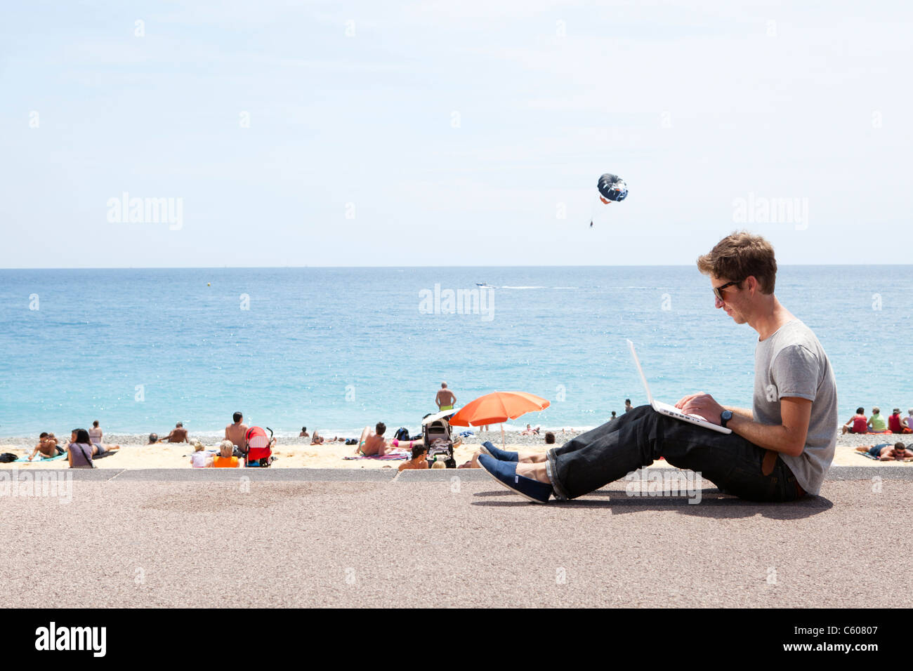 Man on laptop computer, Promenade des Anglais, Nice, France Stock Photo ...