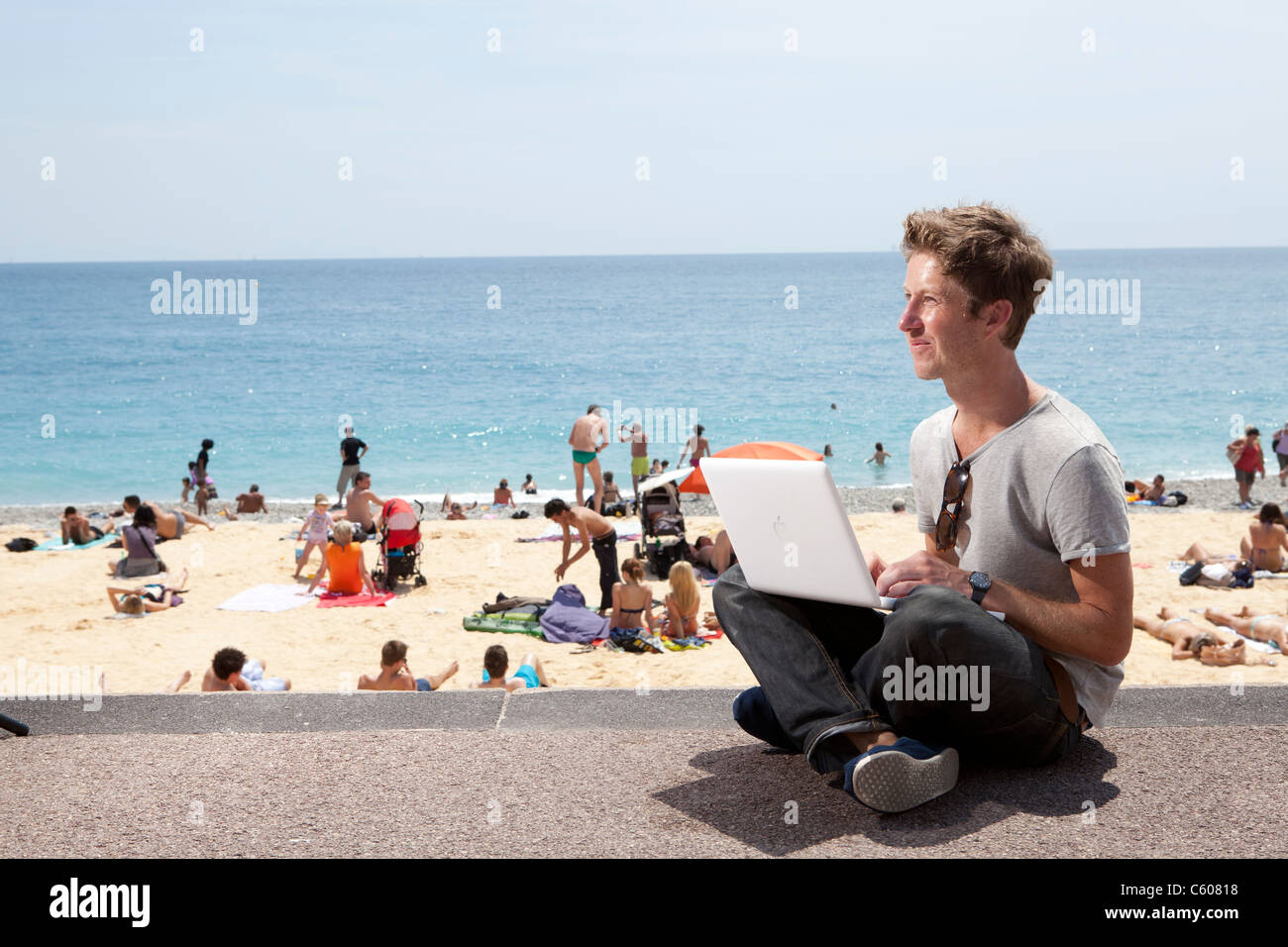 Man on laptop computer, Promenade des Anglais, Nice, France Stock Photo ...