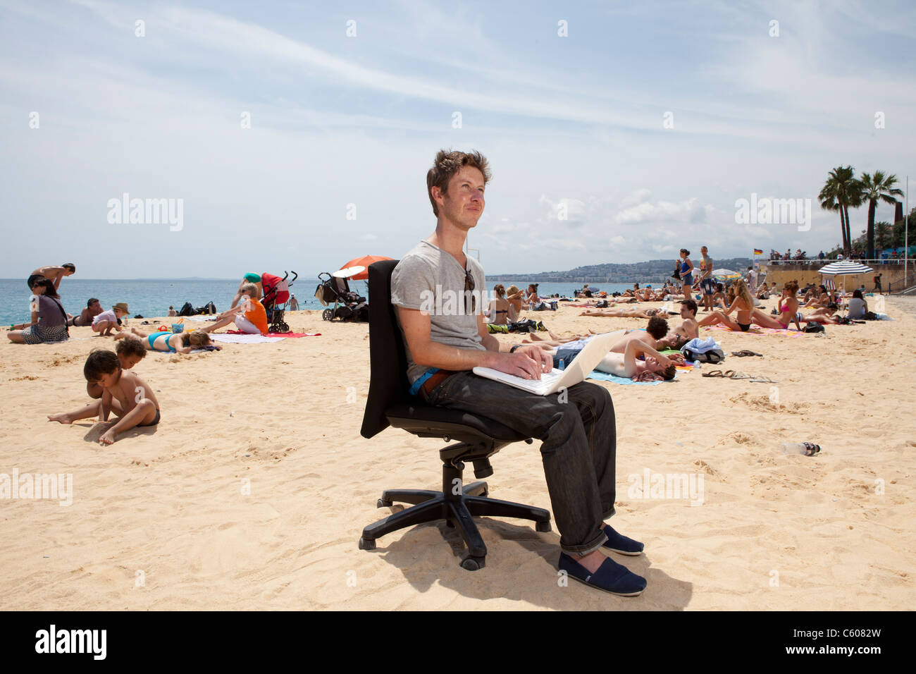 Man on laptop computer, Promenade des Anglais, Nice, France Stock Photo ...