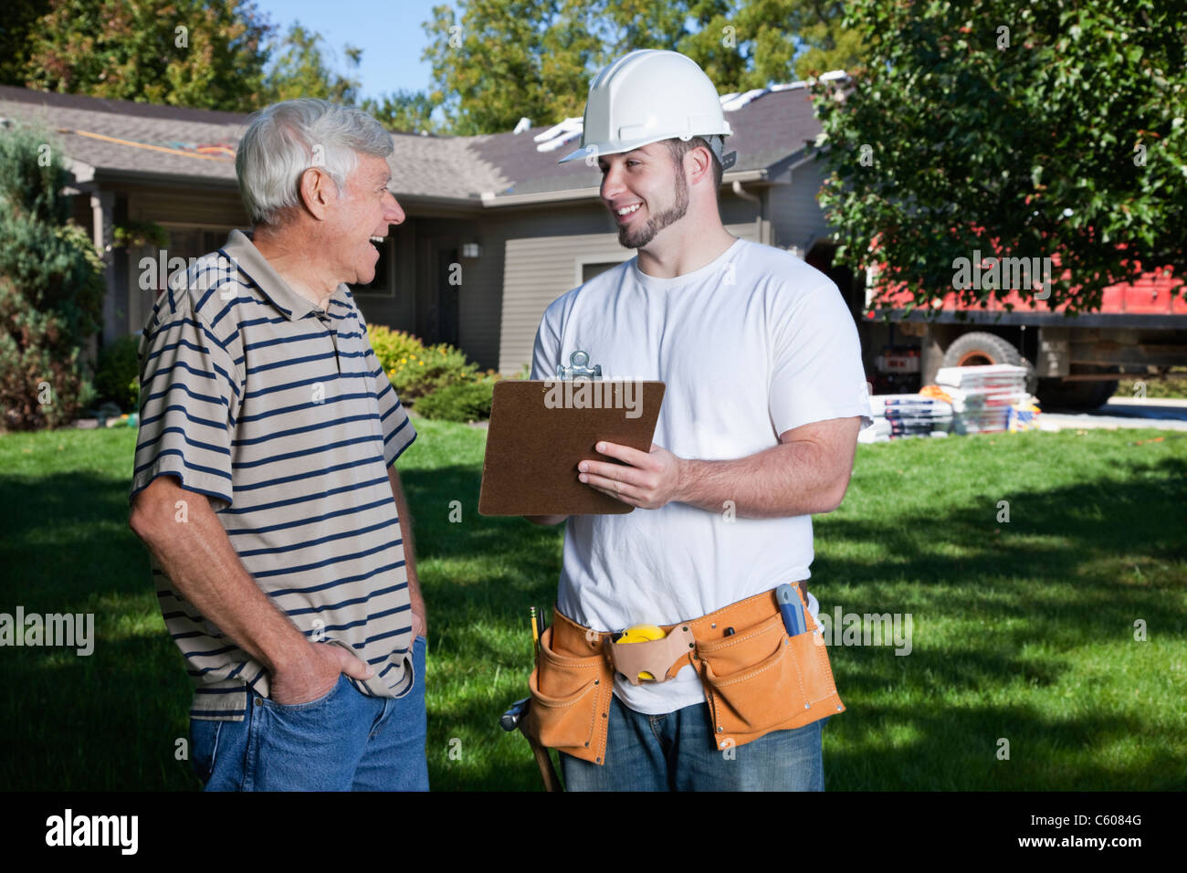 USA, Illinois, Metamora, Home owner with construction worker holding ...