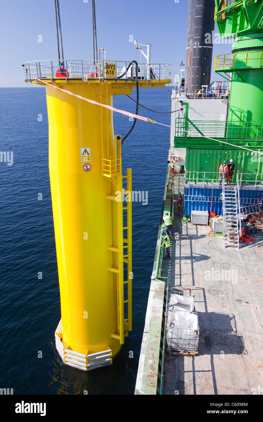 A jack up barge lifts a transition piece into place on the Walney ...