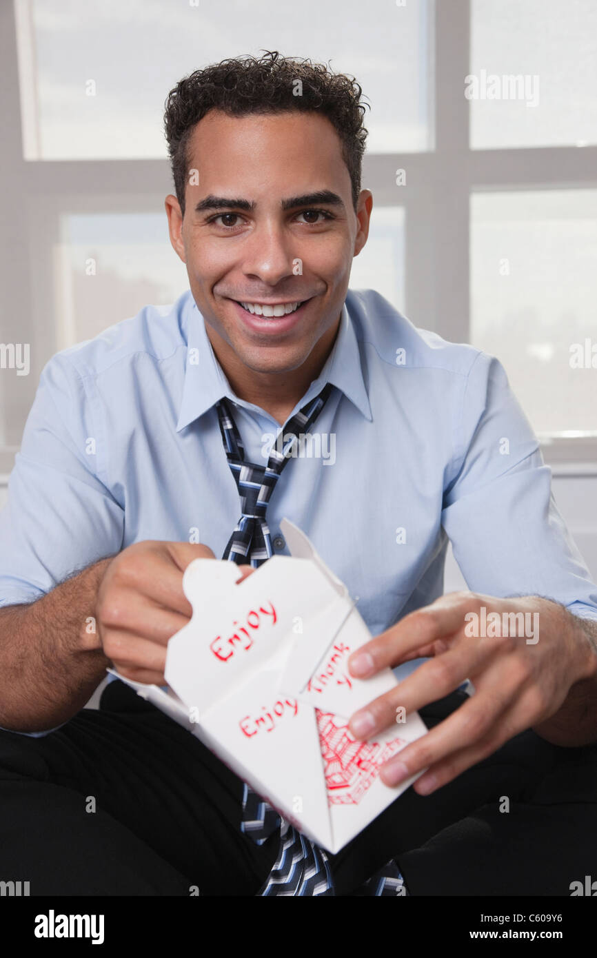 USA, New York, New York City, portrait of smiling young man eating ... USA, New York, New York City, portrait of smiling young man eating ...