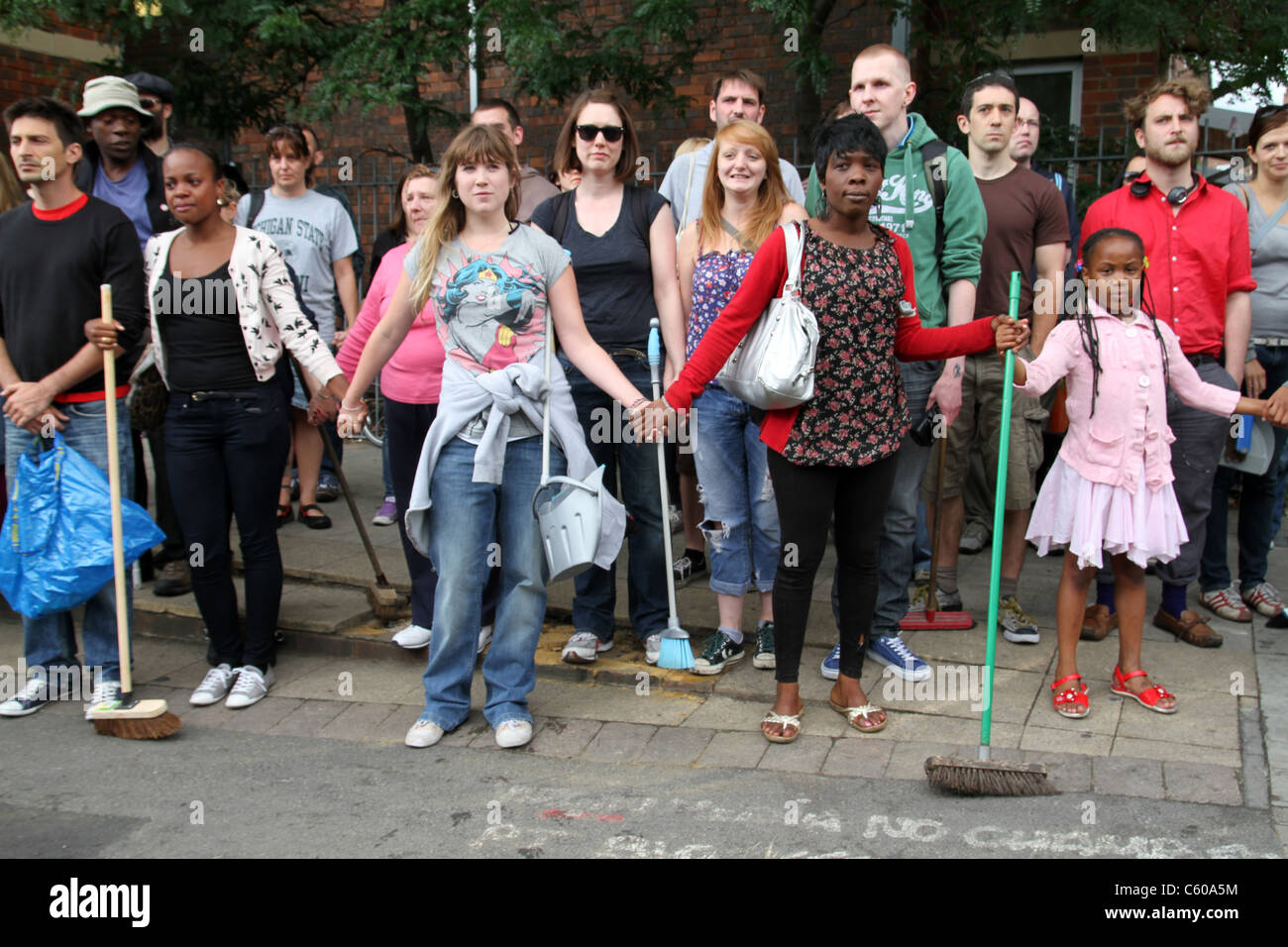 Local community get together to clear damage caused by rioters and ...