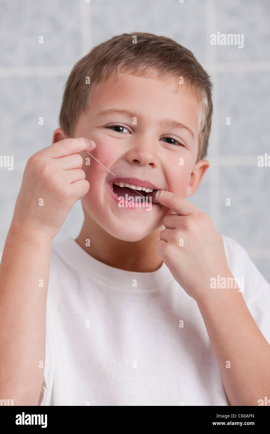 Boy flossing teeth hi-res stock photography and images - Alamy