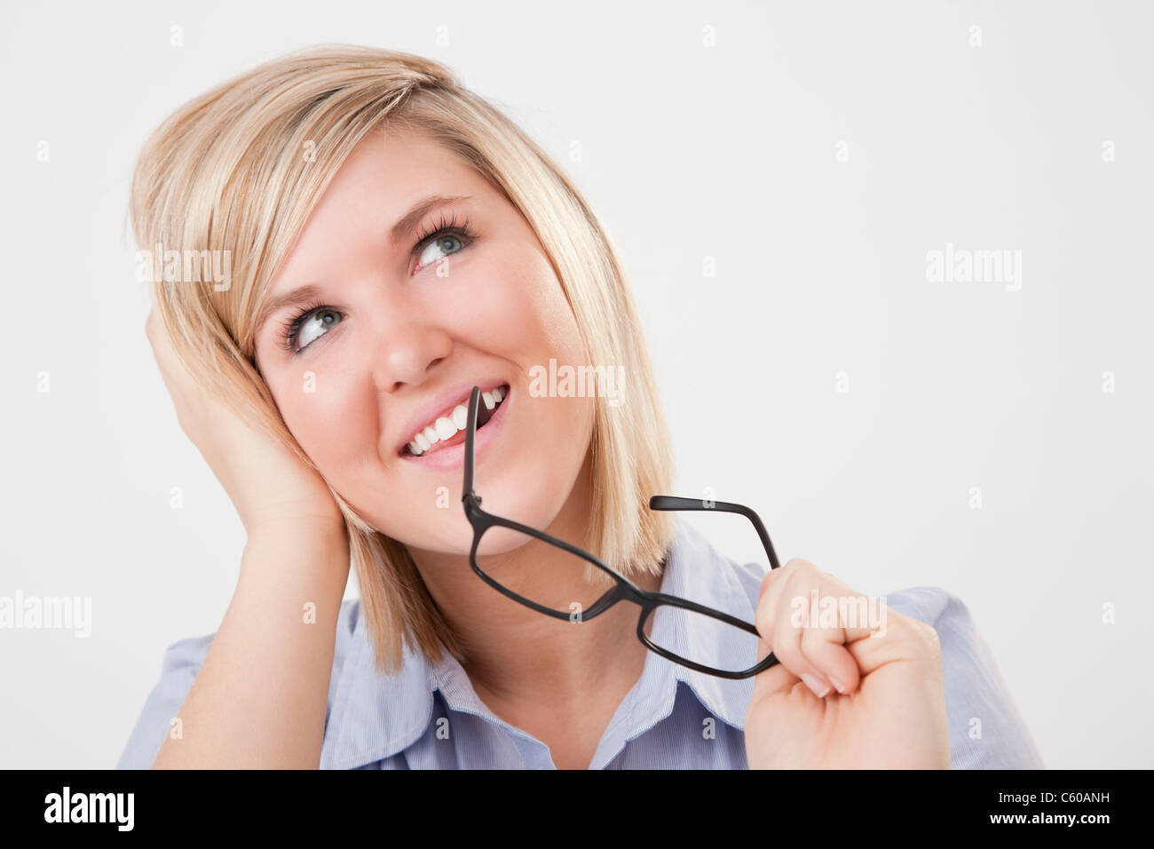 USA, Illinois, Metamora, studio portrait of young woman biting ...