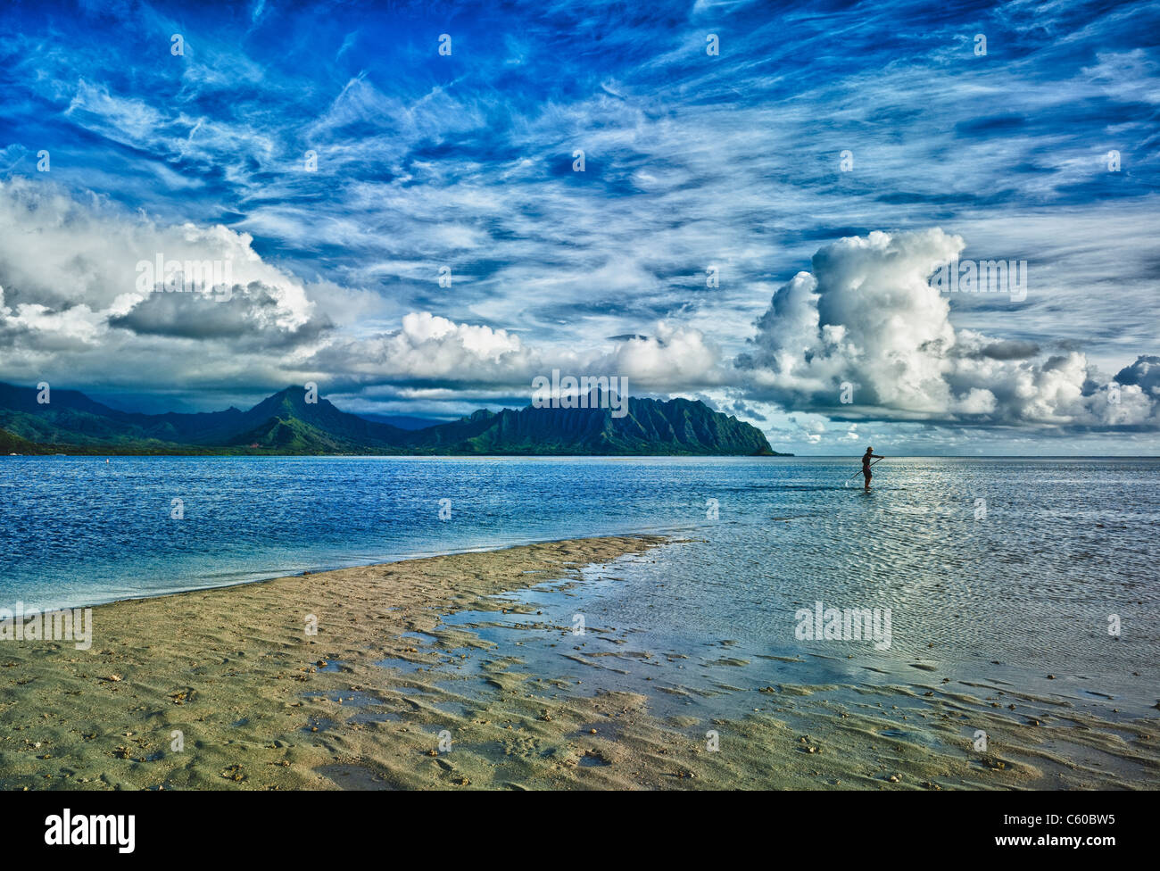 Stand-up Paddler at Kaneohe Bay Sandbar for sunrise, Kualoa in distance ...