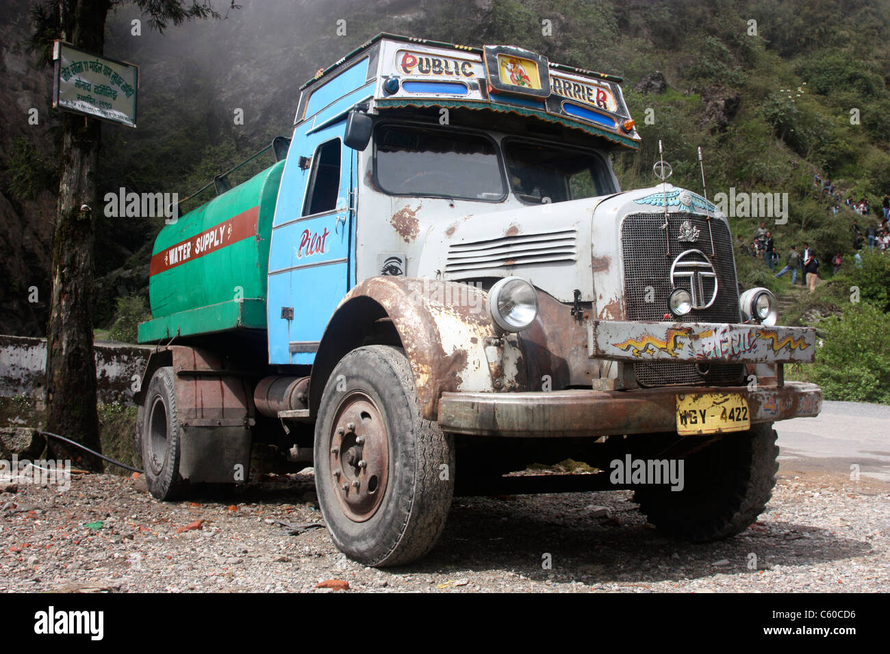 Vintage Tata 1210 SE water bowser supplying local water filling up its ...
