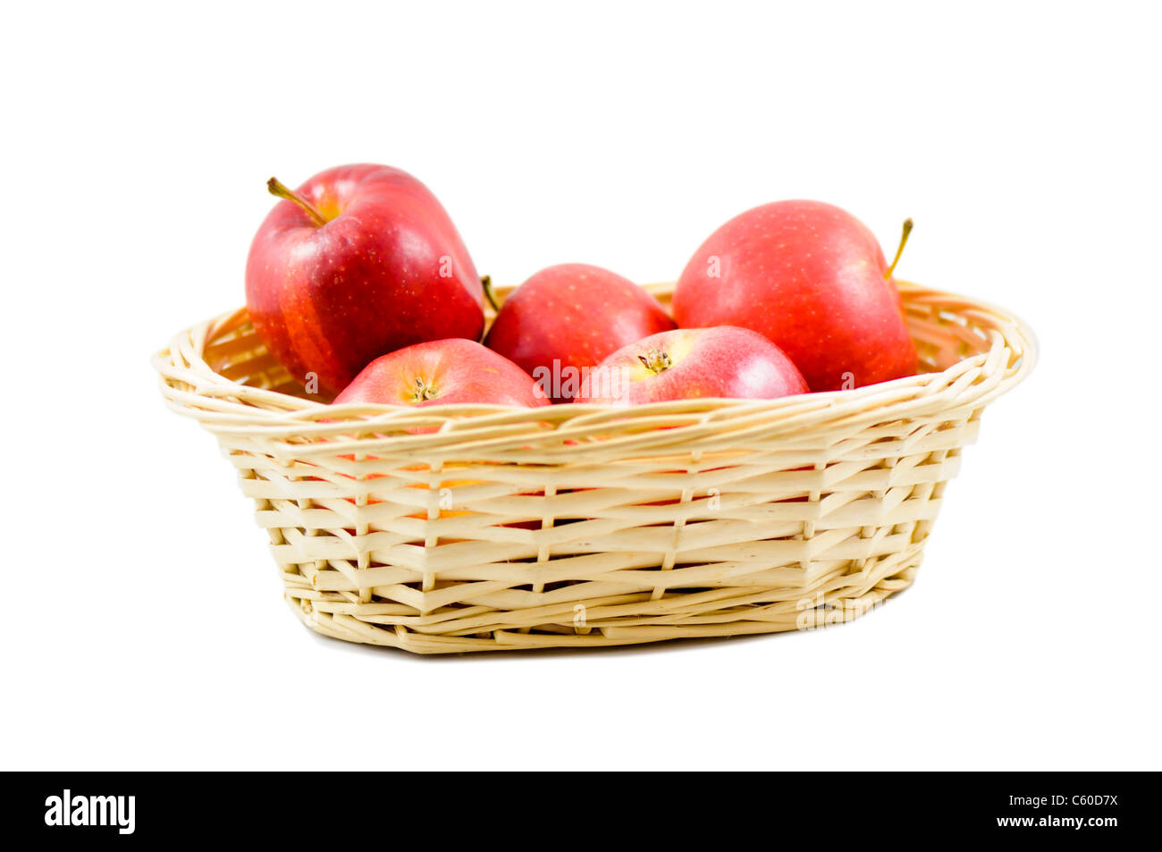 Red apples in a basket isolated on white background Stock Photo - Alamy