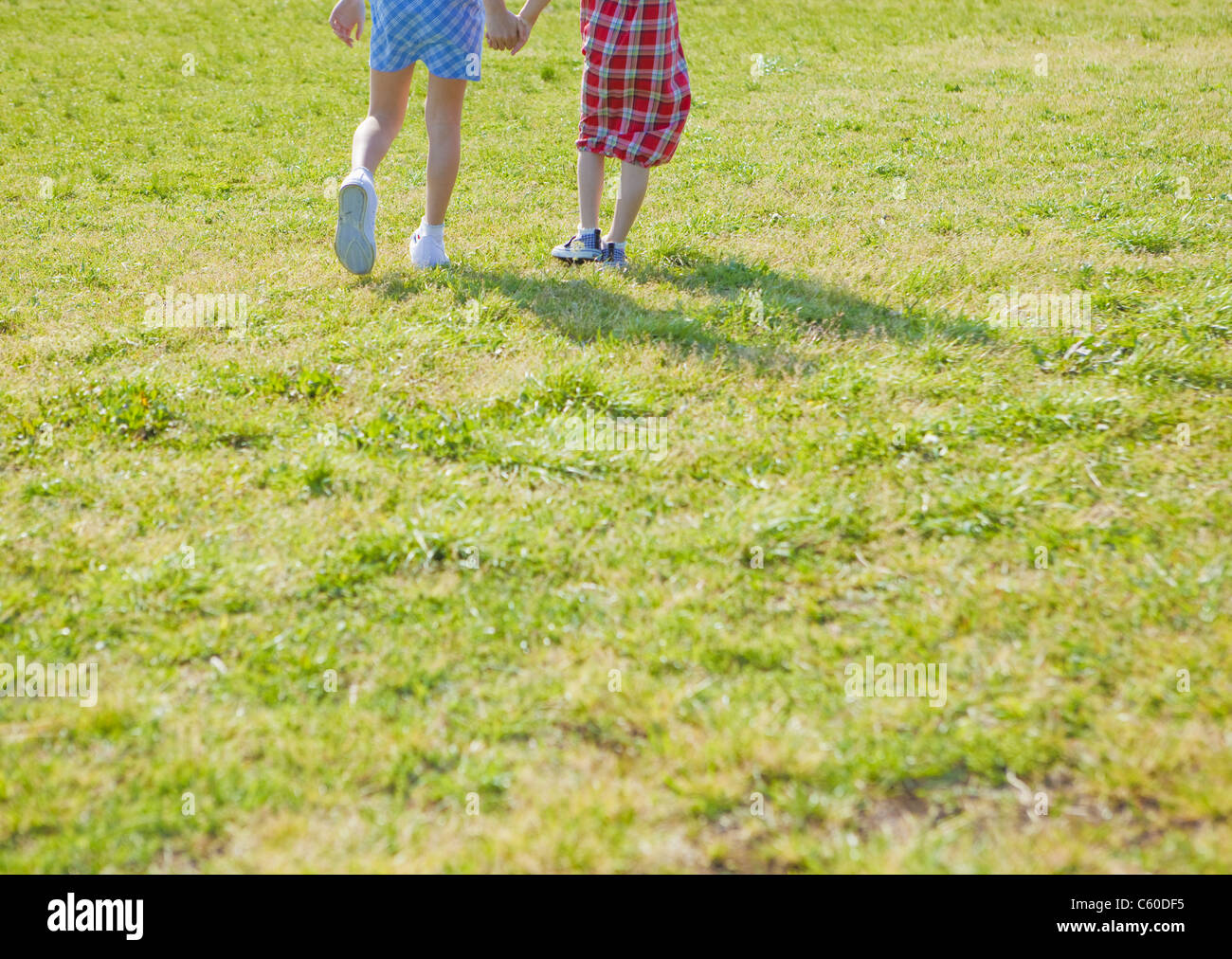 Girls walking on lawn Stock Photo - Alamy