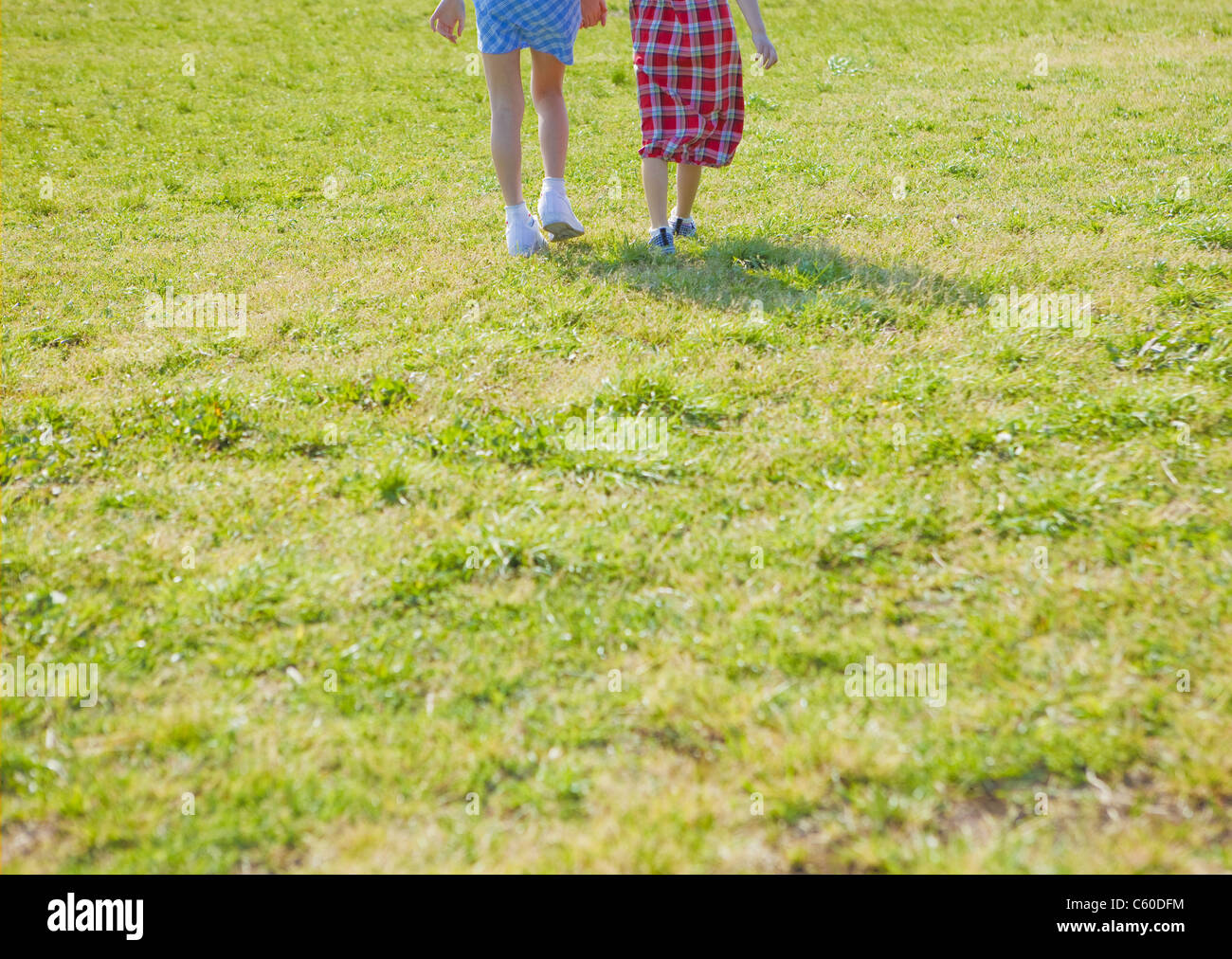 Girls walking on lawn Stock Photo - Alamy
