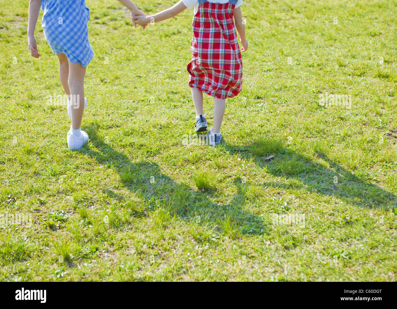 Girls walking on lawn Stock Photo - Alamy