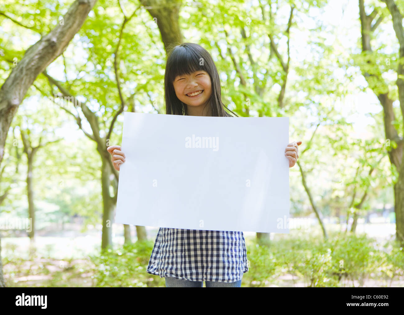 Girl holding drawing paper Stock Photo - Alamy