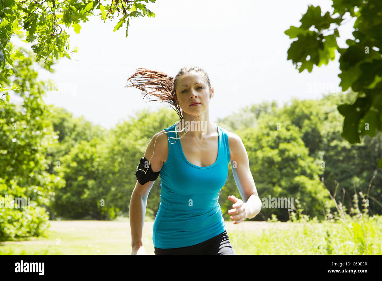 Woman running in forest Stock Photo - Alamy