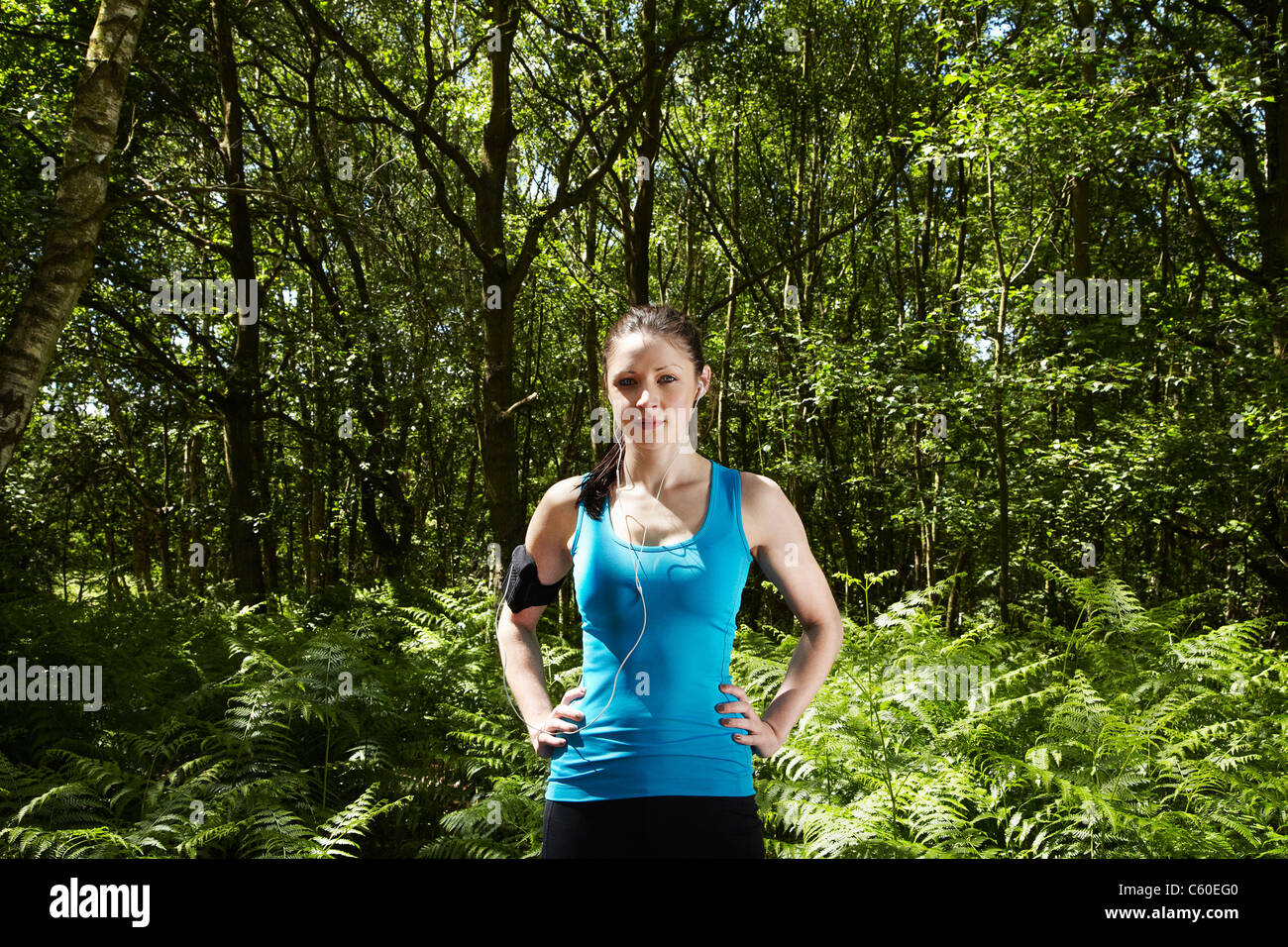 Runner standing in forest Stock Photo - Alamy