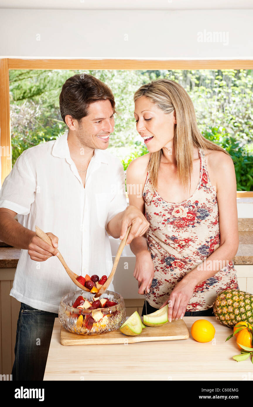 Couple cooking together in kitchen Stock Photo - Alamy