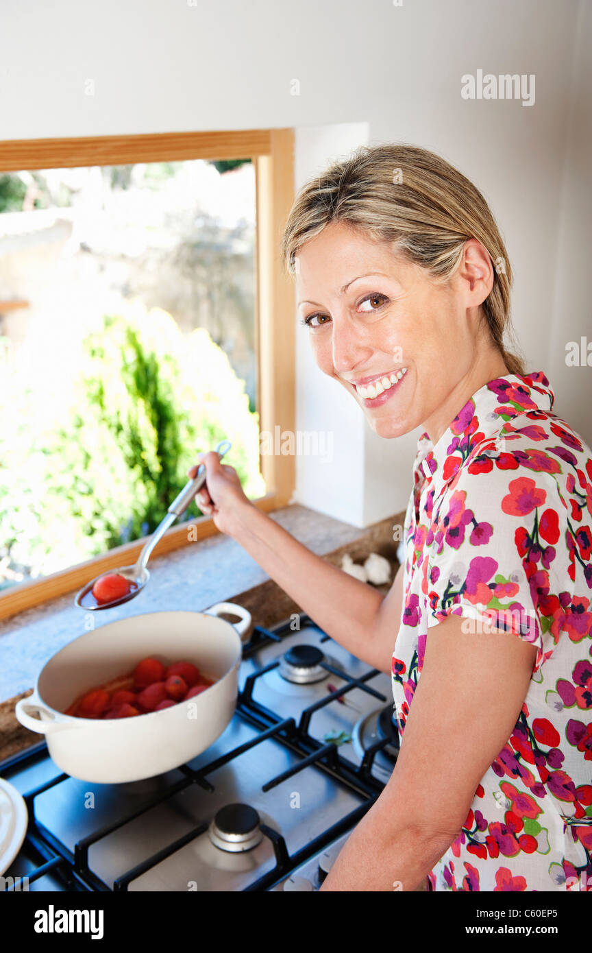 Woman cooking in kitchen Stock Photo - Alamy