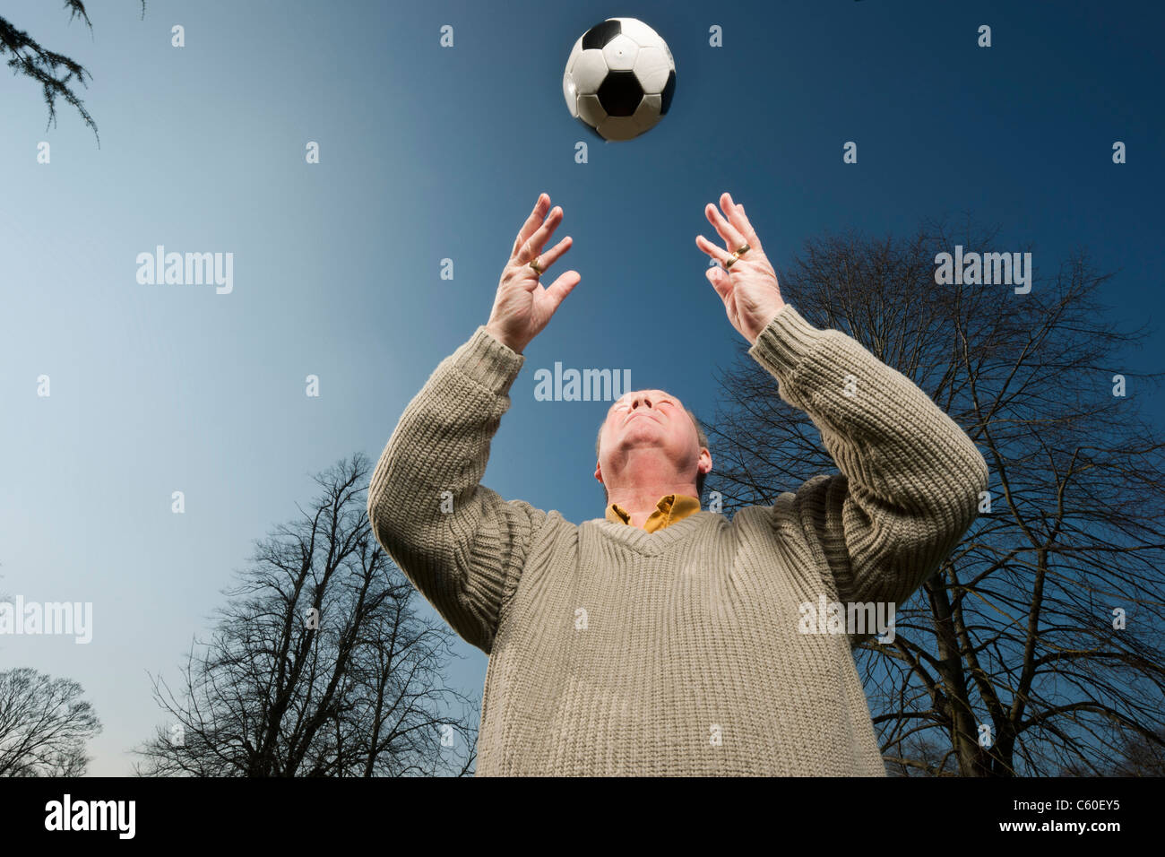 Older man playing with soccer ball Stock Photo - Alamy